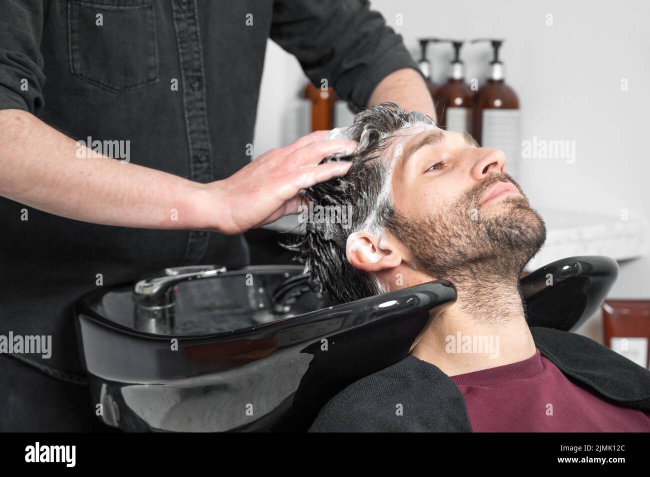 Barber shop hairdresser man washes hi-res stock photography and images ...