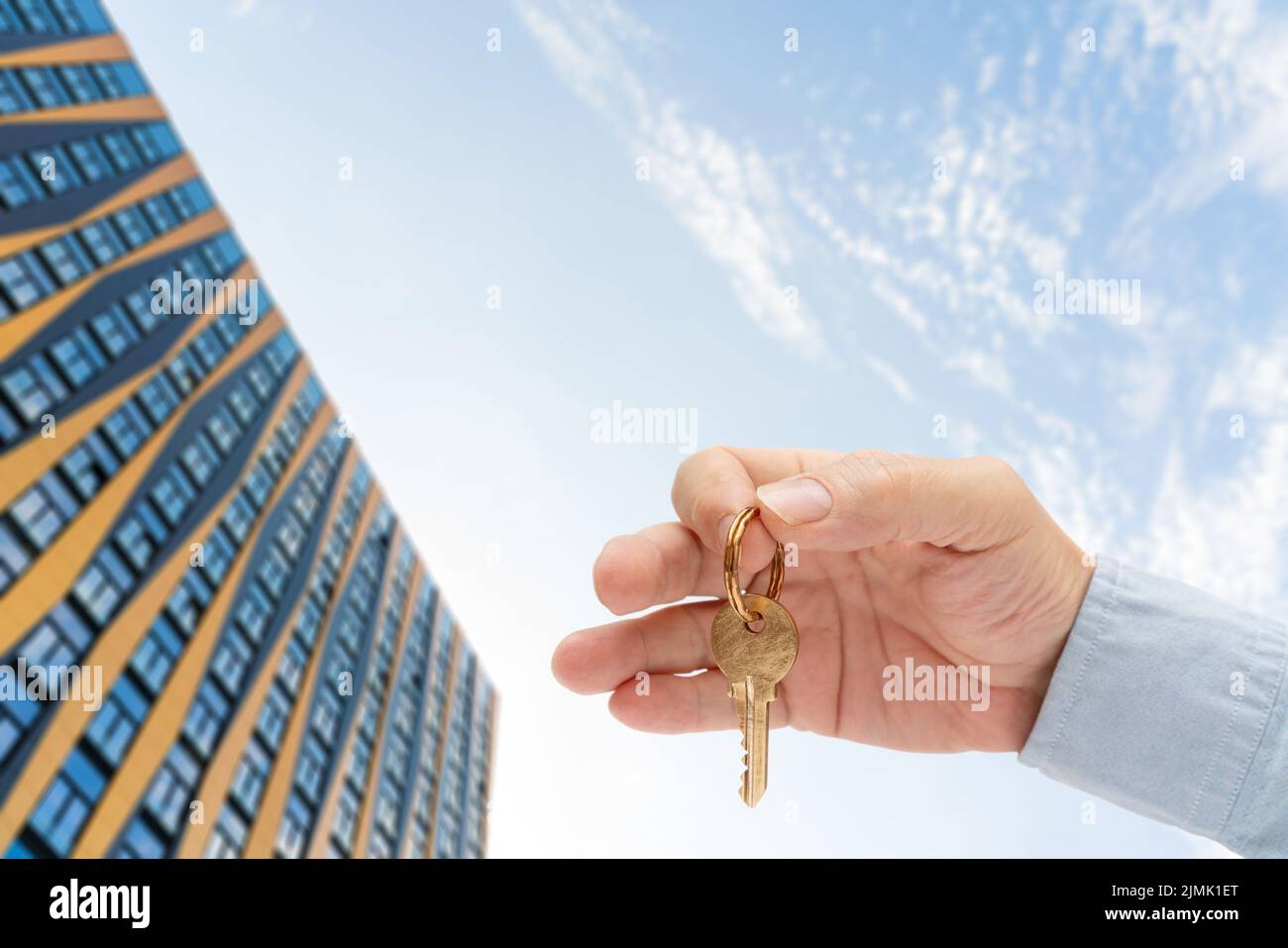 Apartment key in a man's hand. Brass house door lock key. Modern ...