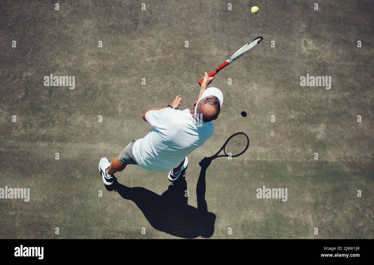 What a shot. High angle shot of a focused middle aged man playing ...
