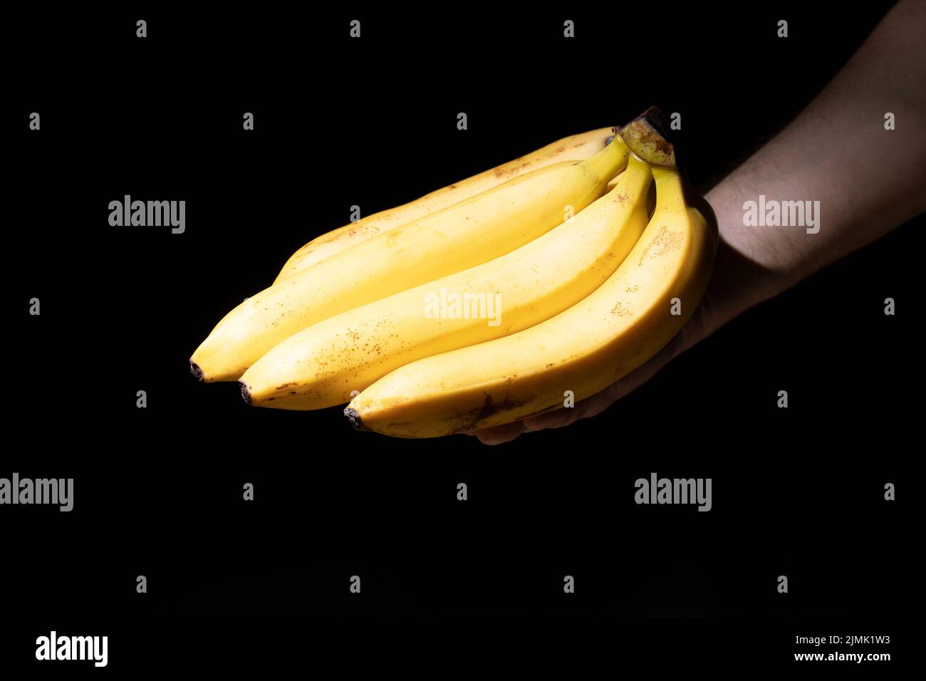 Hand holds bunch of bananas hi-res stock photography and images - Alamy