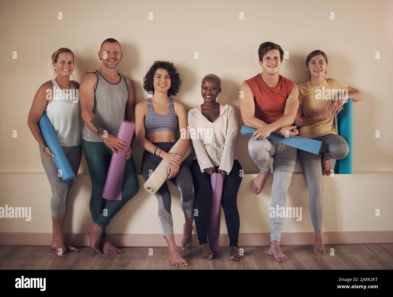 This is the best yoga group. Full length portrait of a diverse group of ...