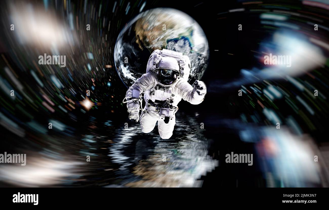 Astronaut in space in the solar system Earth. Blue light on background ...