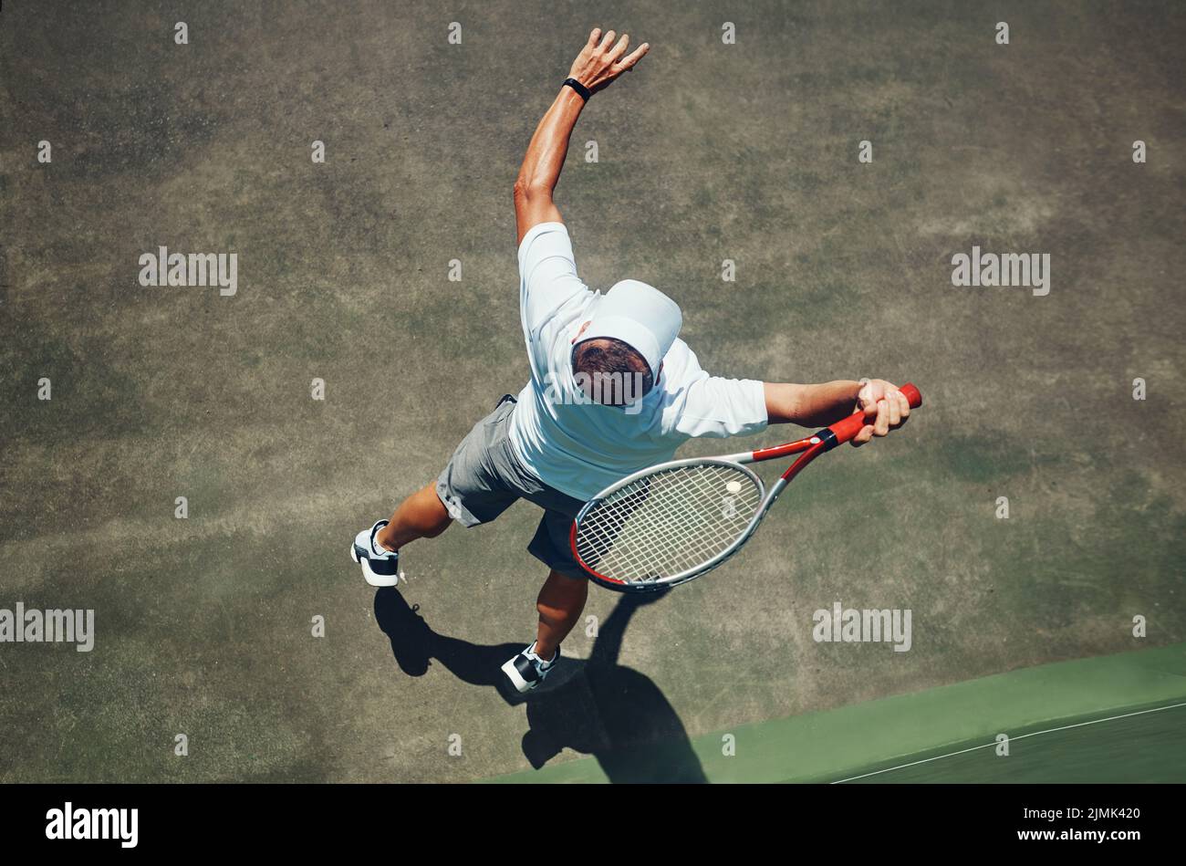 I win the set. High angle shot of a focused middle aged man playing ...