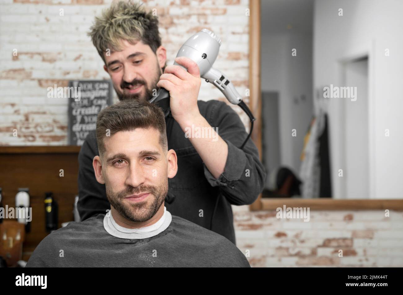 Barber working hair dryer hi-res stock photography and images - Alamy