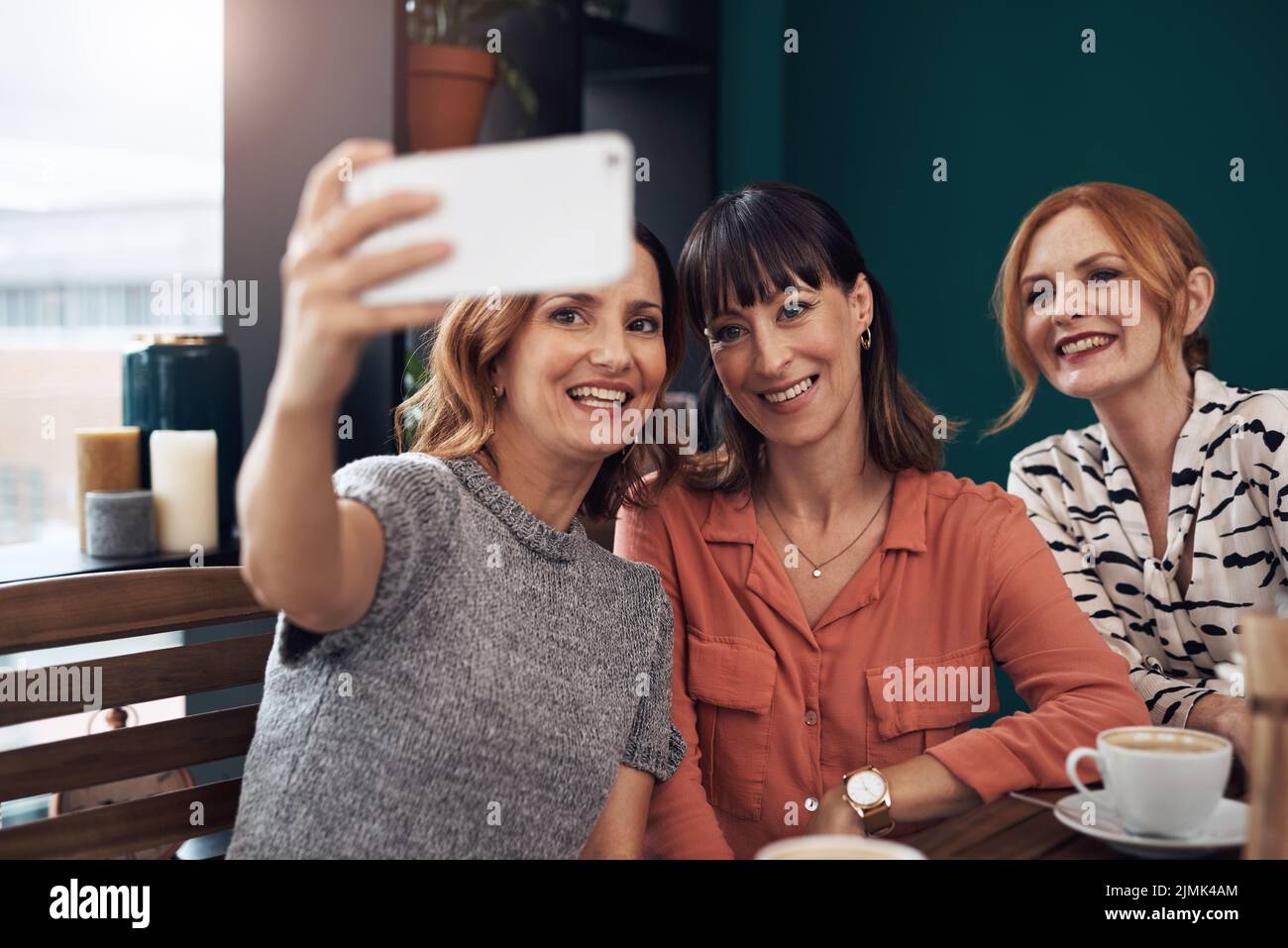 Everyone smile. a group of attractive middle aged women taking a self ...