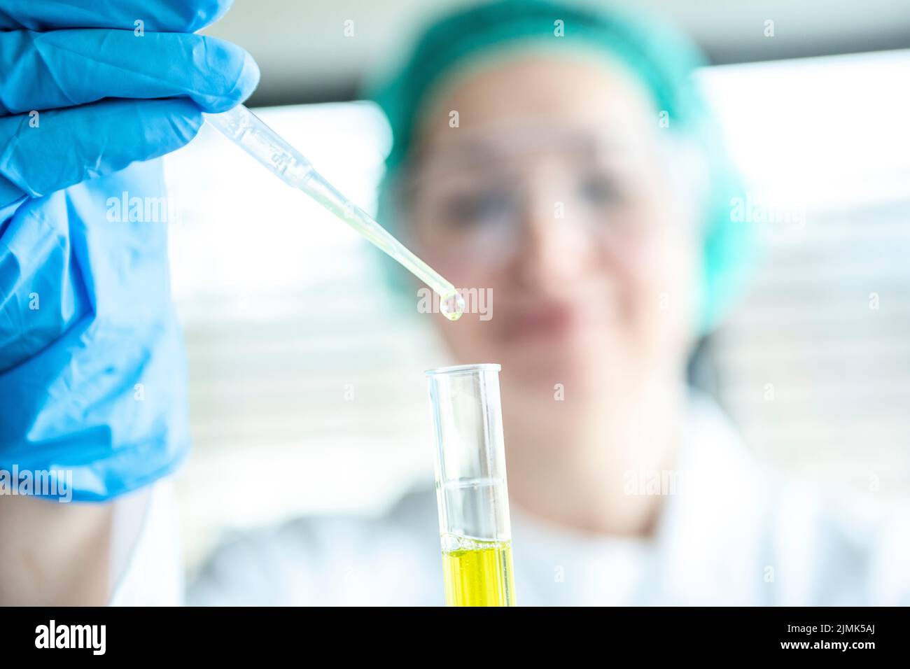 Woman Scholar Dropper And Test Tube Stock Photo - Alamy