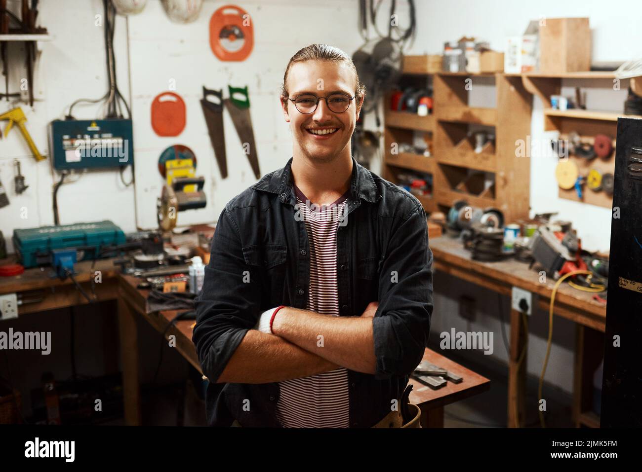 A job well done. Portrait of a confident young male carpenter standing ...