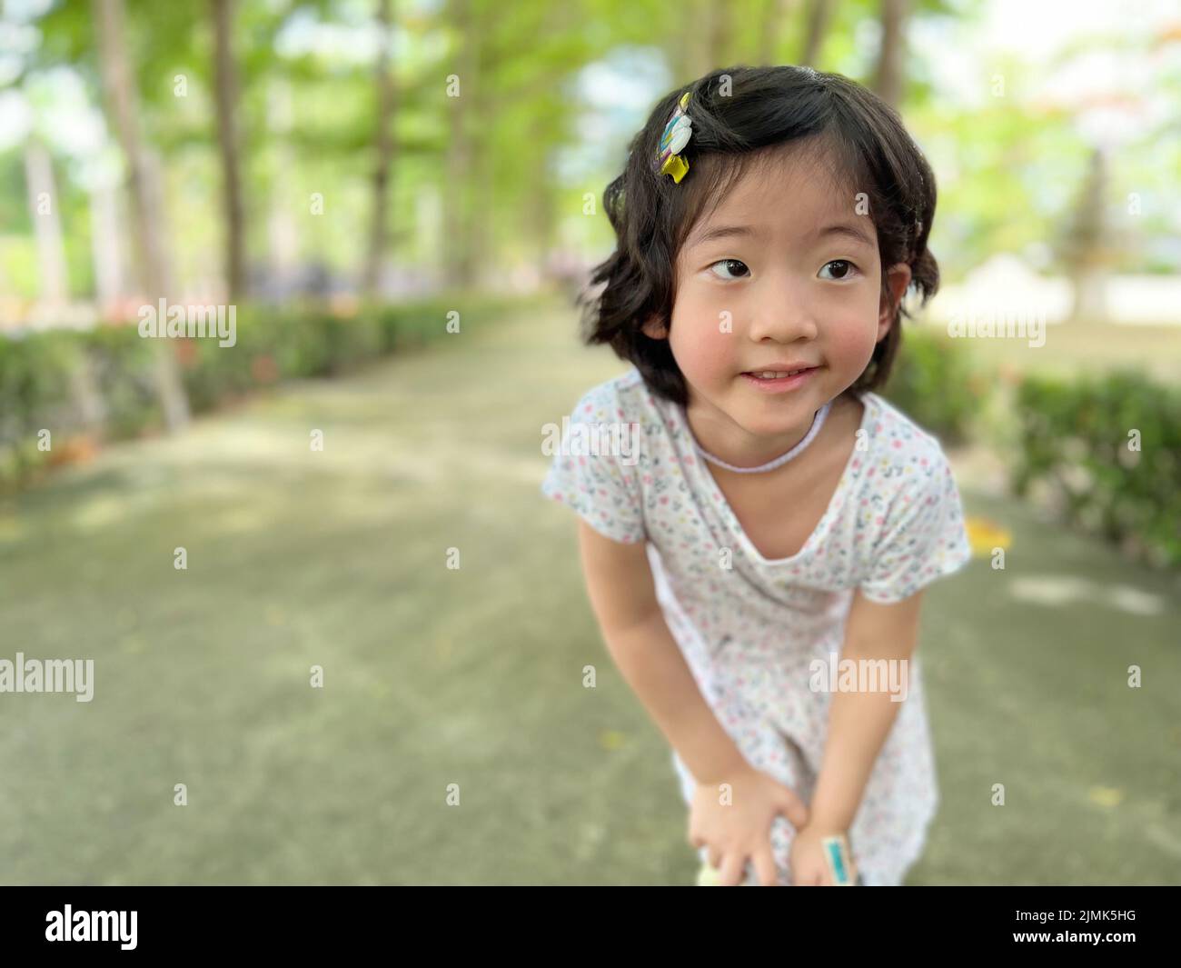 cute little girl smile with beautiful pose in the garden with copy ...