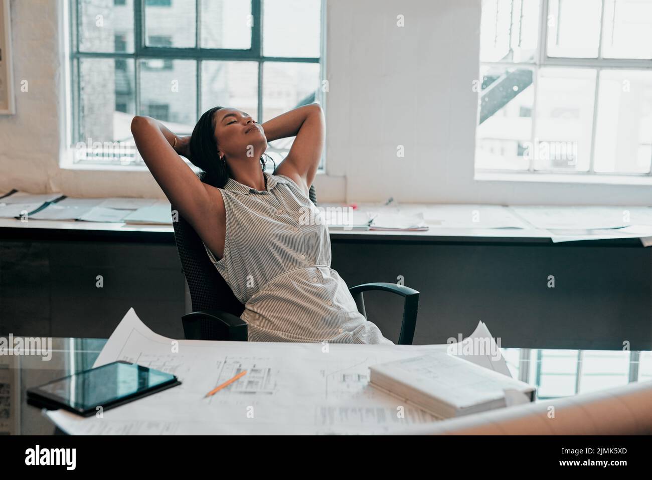 Basking in total job satisfaction. a female architect looking relaxed ...