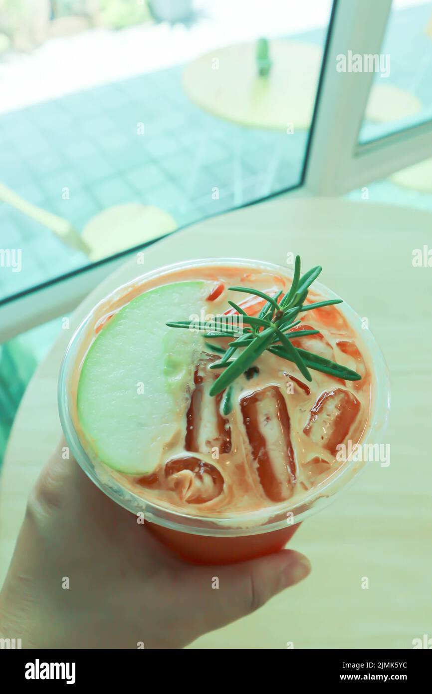 mocktail, fruit juice or punch drink or apple juice with apple topping ...