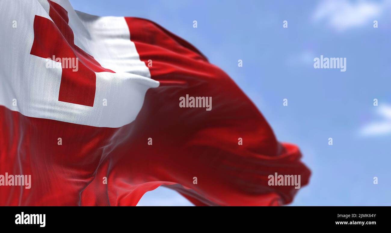 Detail of the national flag of Tonga waving in the wind on a clear day ...