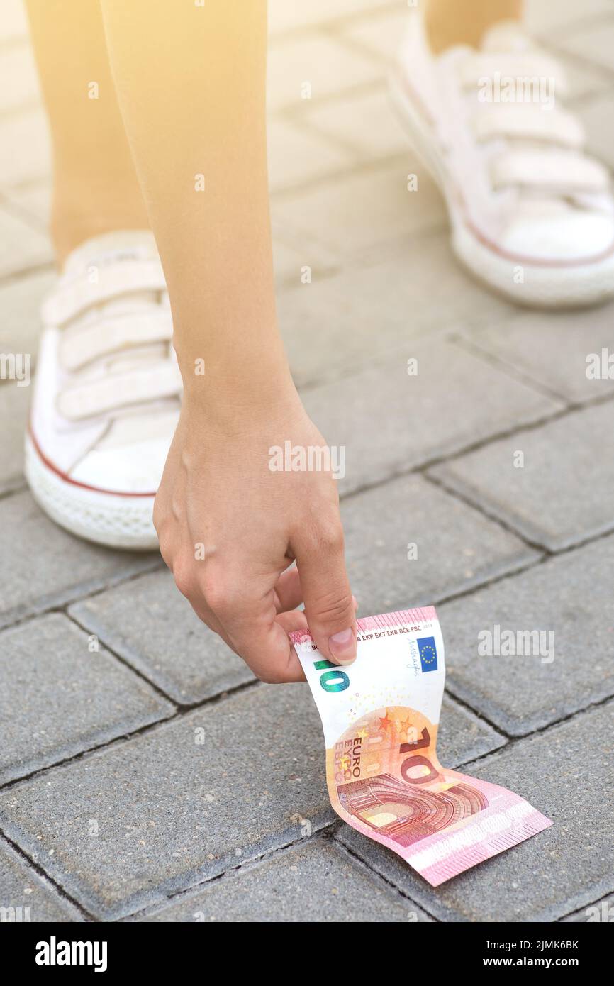 Person picking money ground hi-res stock photography and images - Alamy