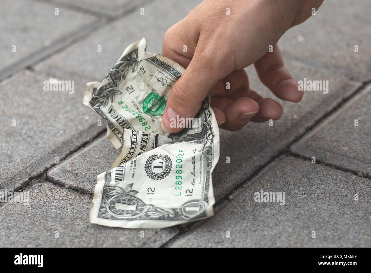 Poor woman picking old and crumpled one dollar bill Stock Photo - Alamy