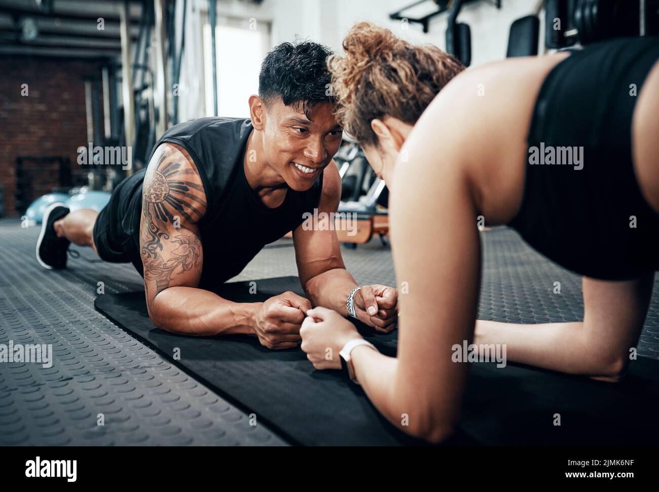 Challenge your limits. two sporty young people working out together at ...