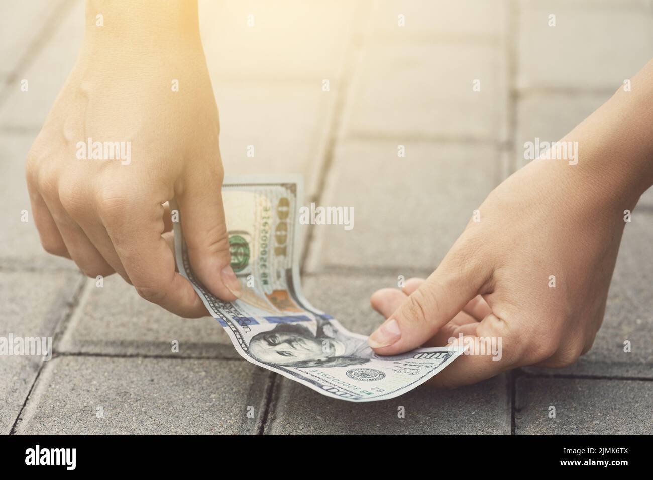 Person picking money ground hi-res stock photography and images - Alamy