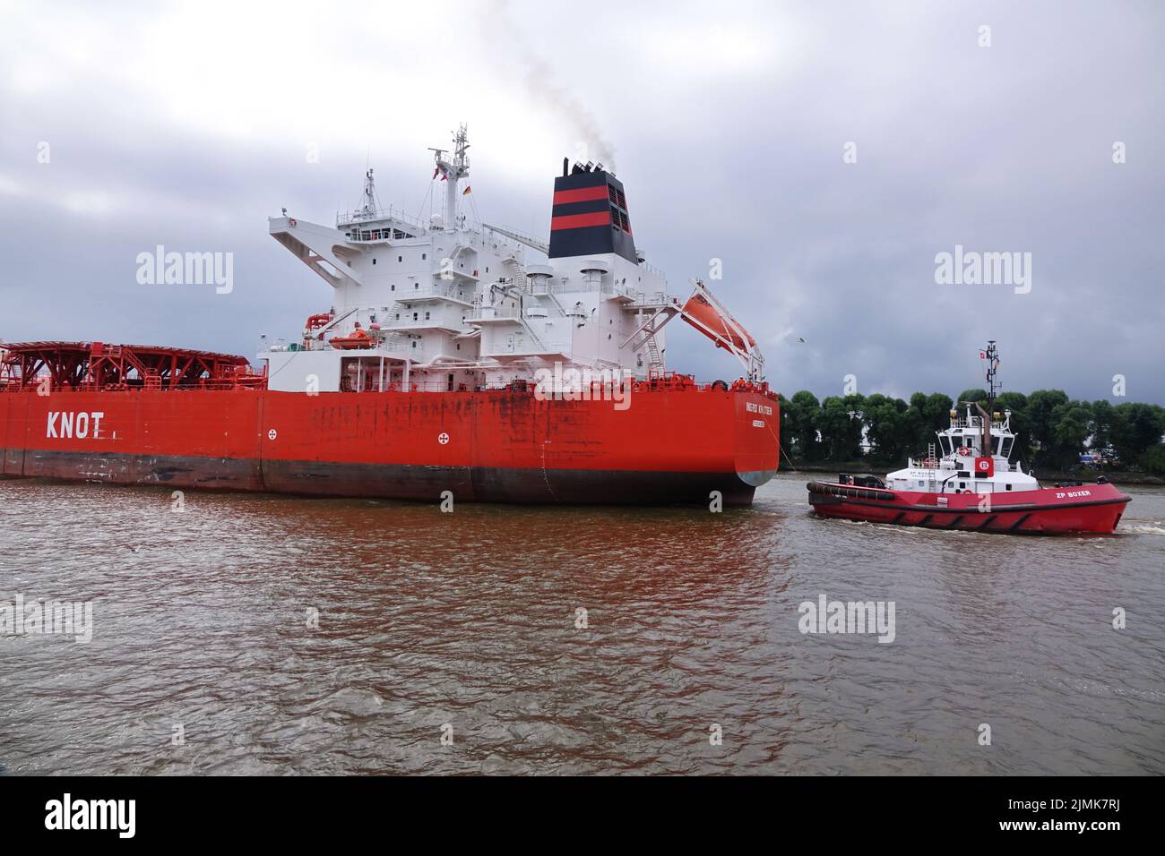 Container ship with tugboat Stock Photo - Alamy