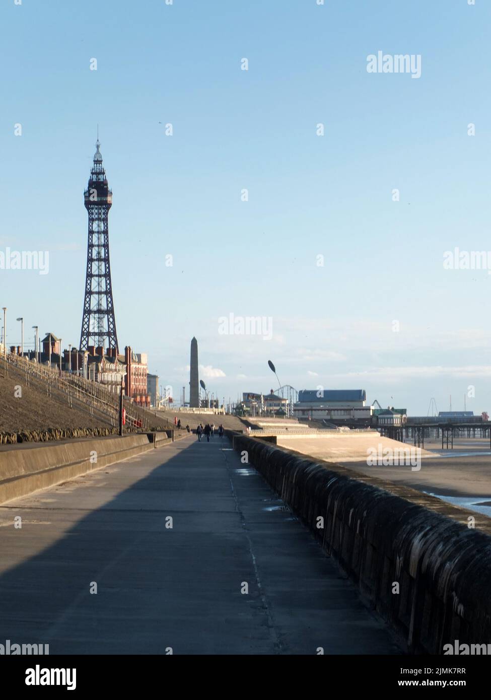 View of blackpool tower and south pier from the promenade with town ...