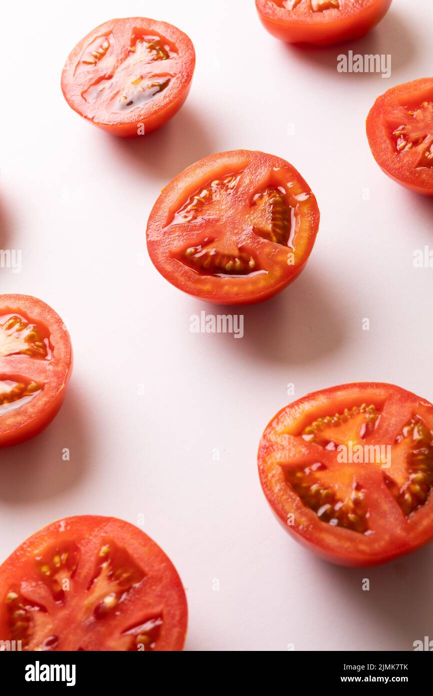 High angle view of fresh tomato halves on white background Stock Photo ...