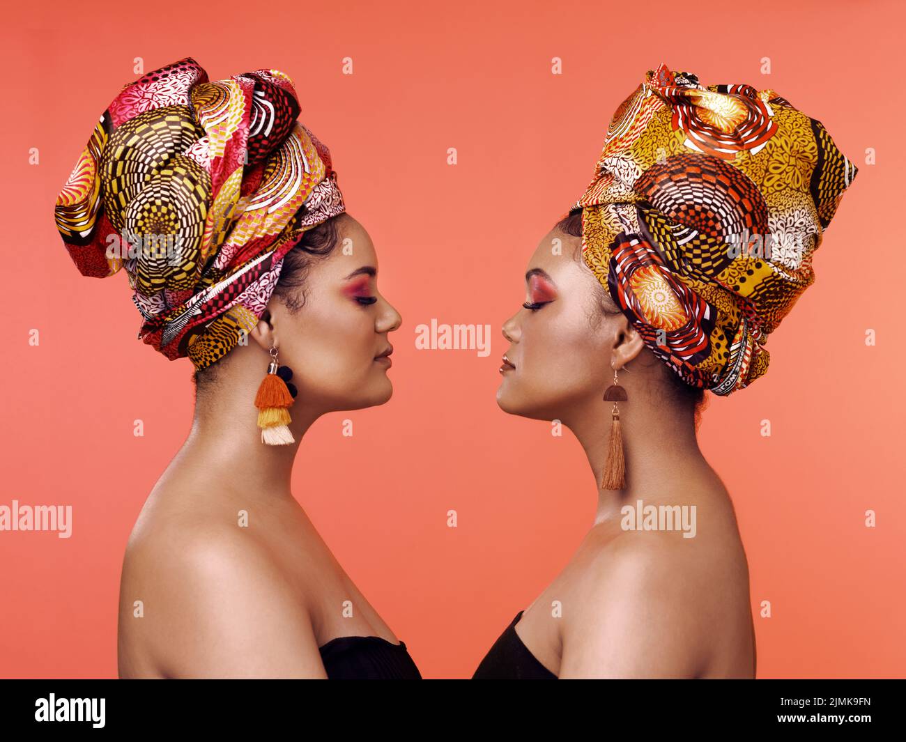African Queens. Studio shot of two attractive young women wearing ...