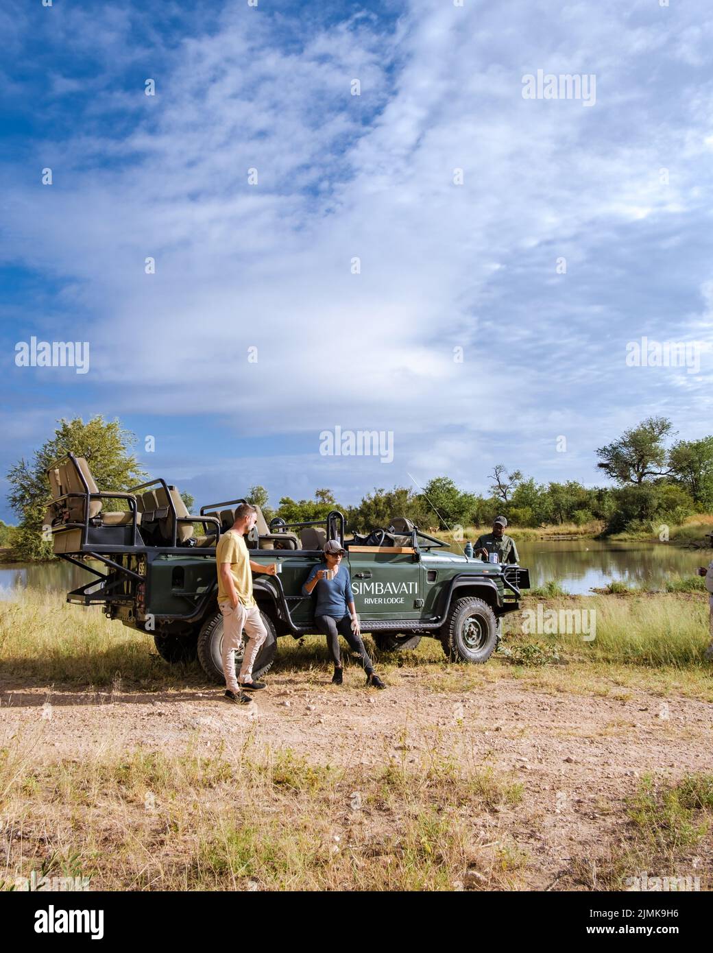 South Africa, luxury safari car during game drive, couple men and woman ...