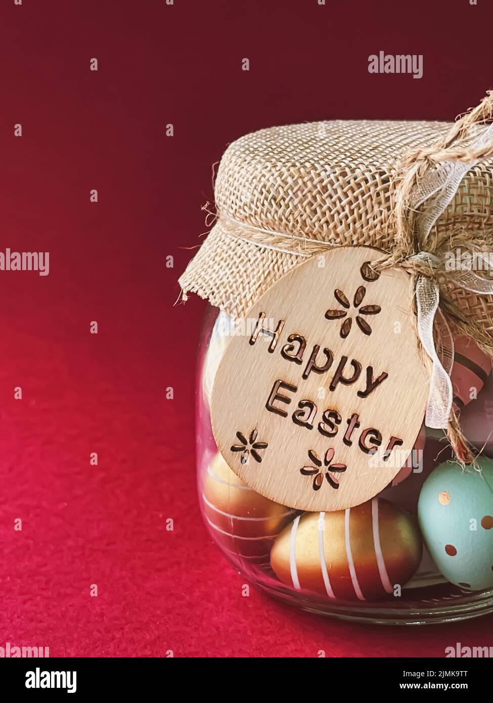 Happy Easter. Colourful painted easter eggs in glass jar on red ...