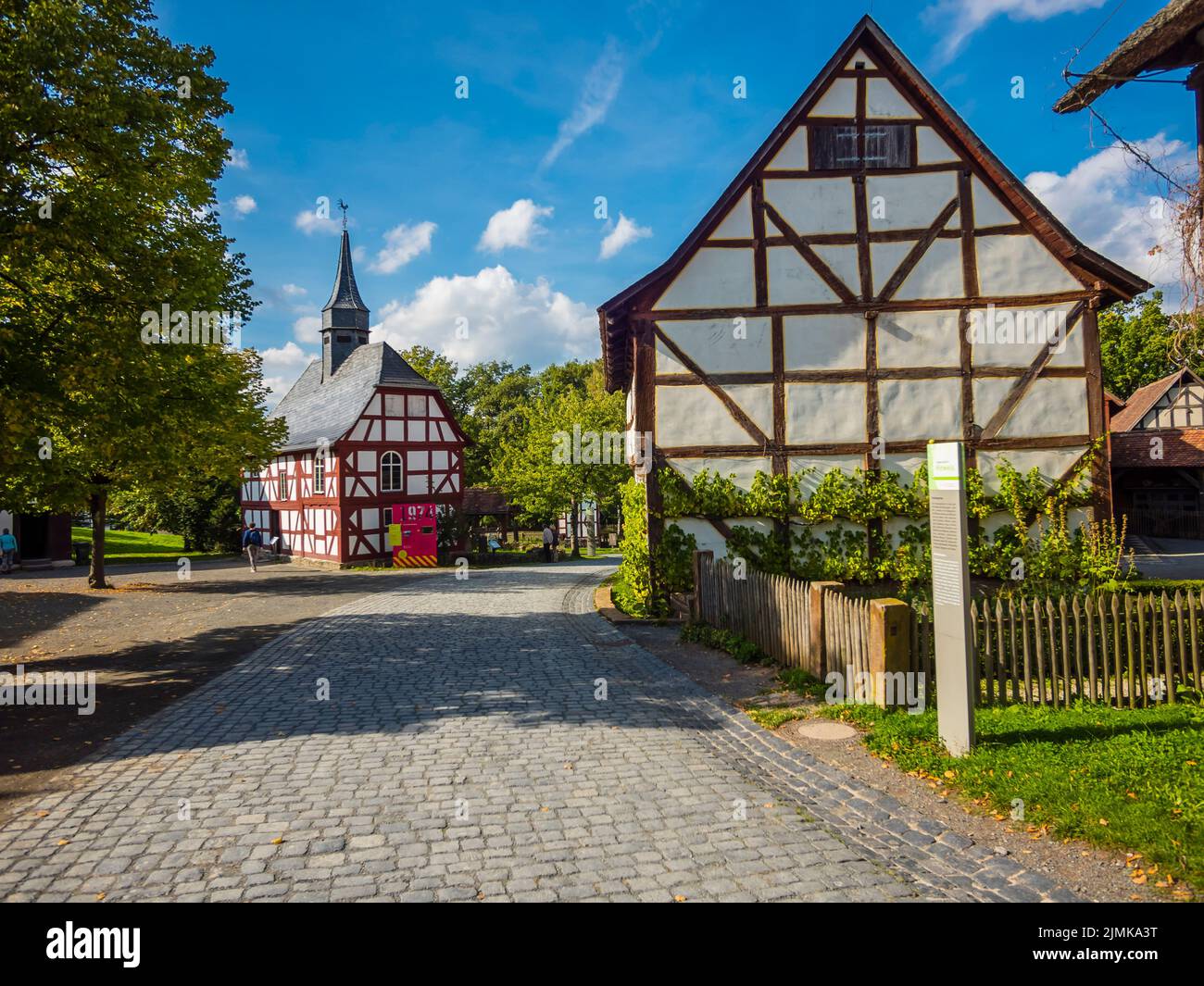 Replica half-timbered houses with village church in Hessenpark open-air ...