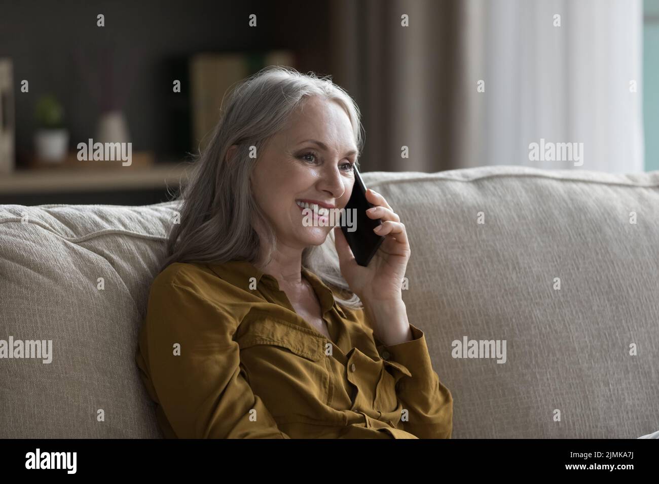 Happy cheerful retired elderly grandma woman talking on mobile phone ...