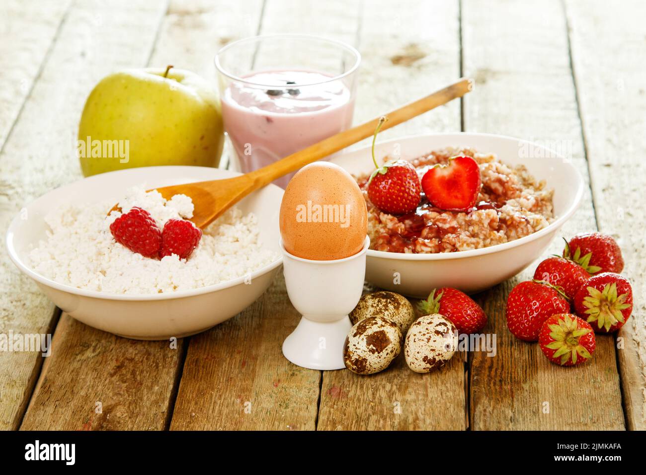 Healthy breakfast. Different food on wooden table Stock Photo - Alamy