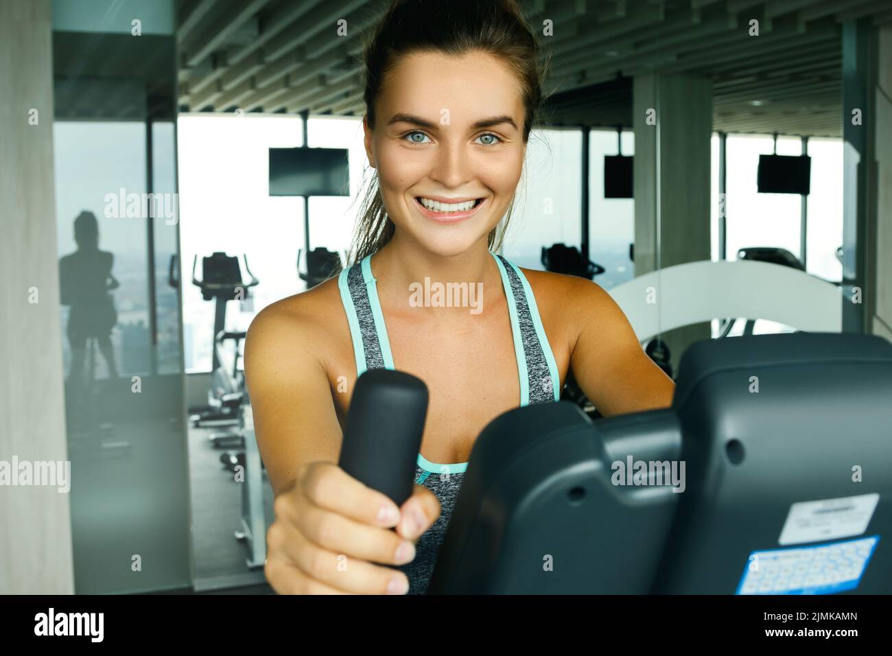 Happy woman during her workout in gym Stock Photo - Alamy