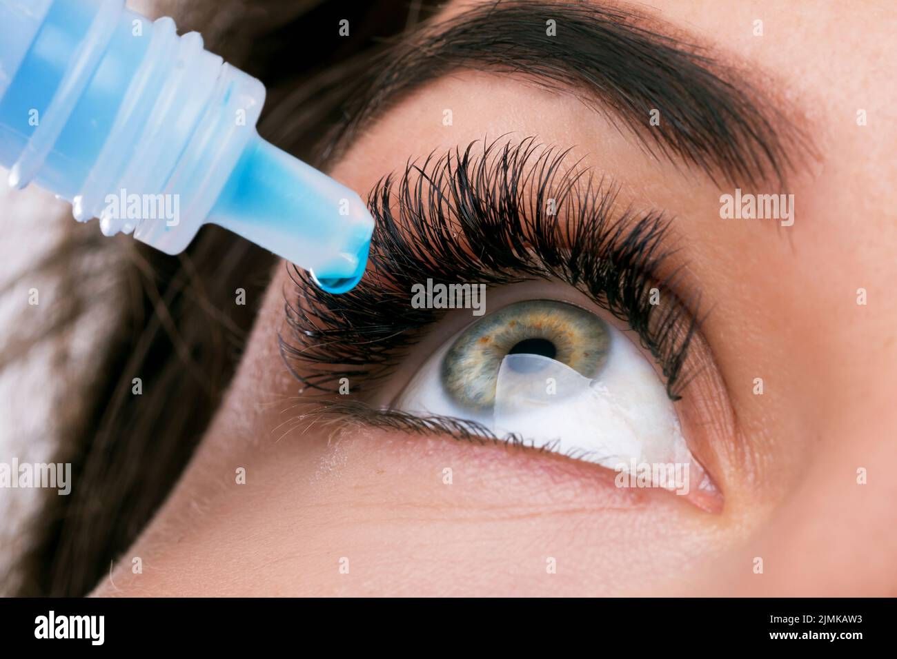 Woman applying eye drops into eye hi-res stock photography and images ...