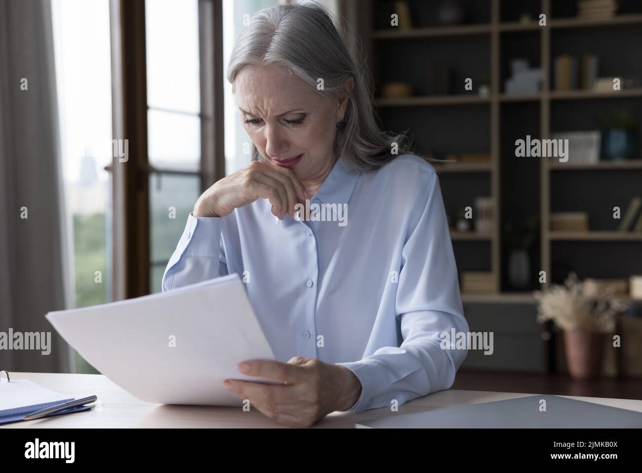 Sad elderly business woman receiving bad shocking news about loss Stock ...
