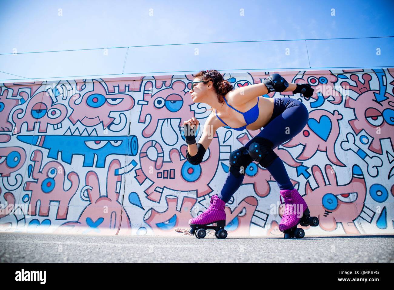 Athletic girl doing gymnastics with roller skates Stock Photo - Alamy