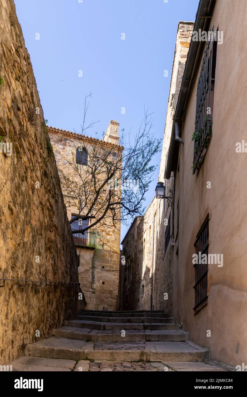 Narrow pedestrian cobblestone street leading through the historic old ...