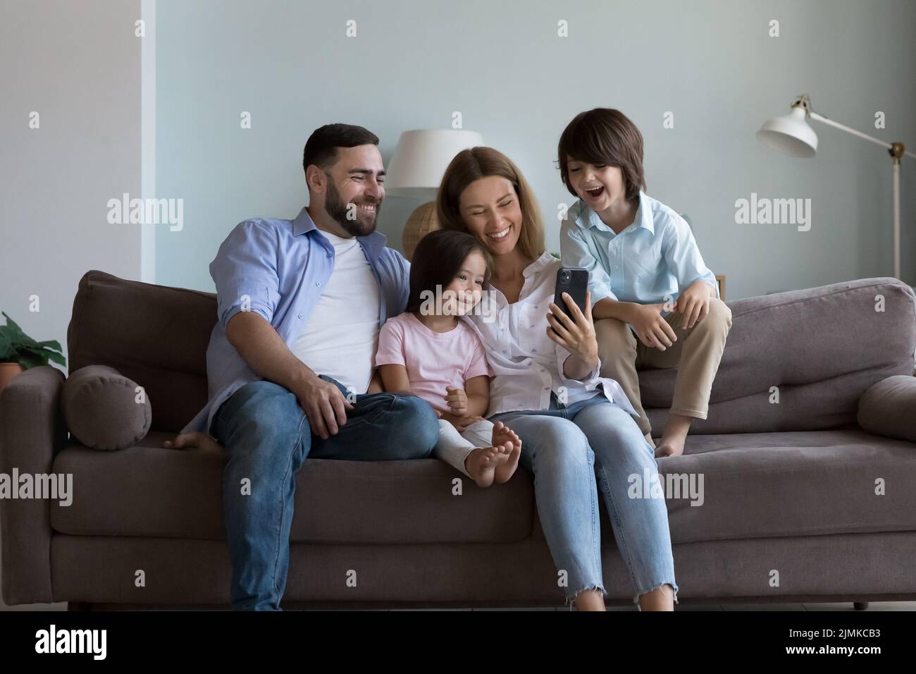 Children and parents watch videos on internet use smartphone Stock ...