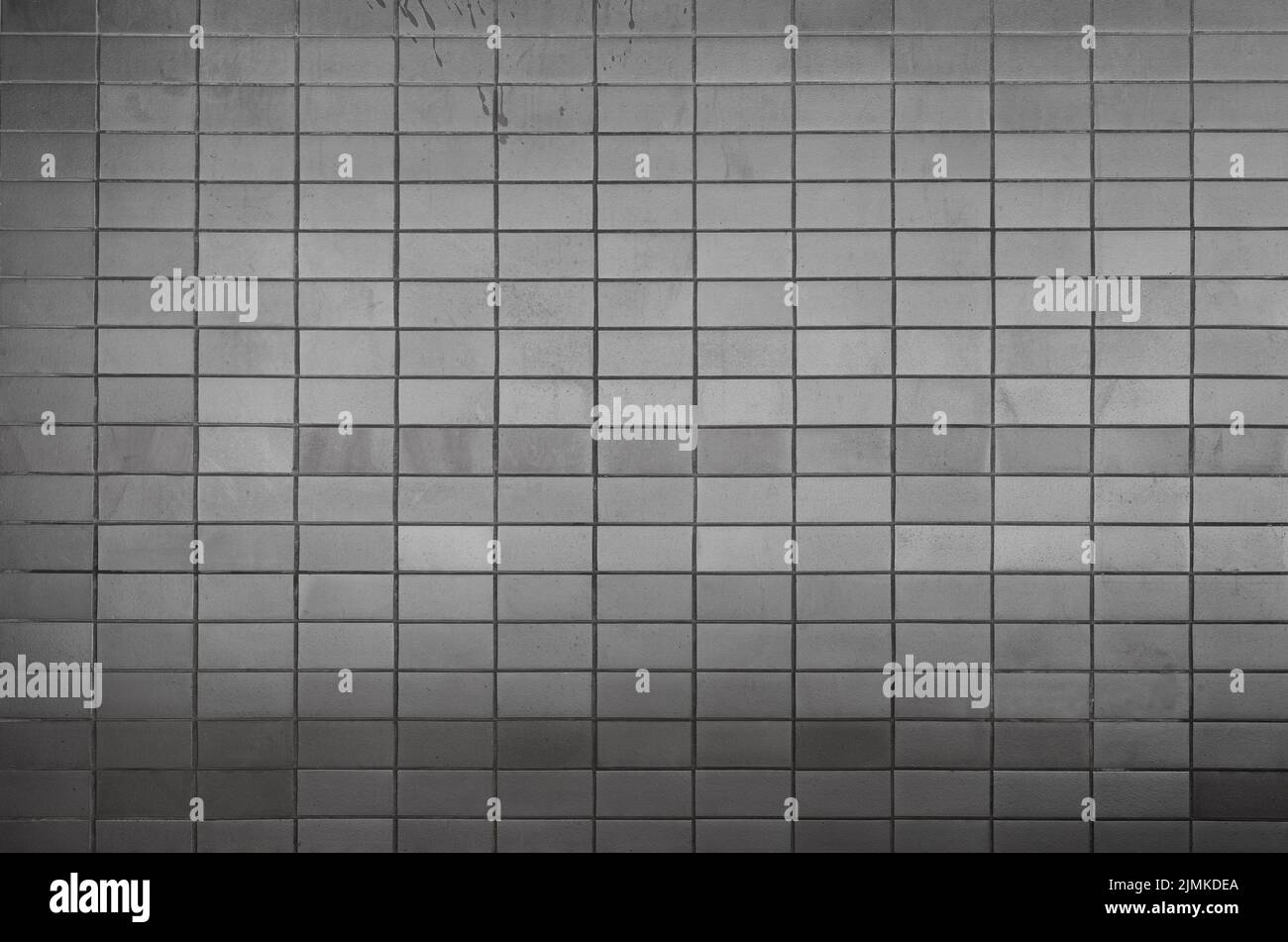 Wall made of tiles or blocks with some stains, front view. High ...