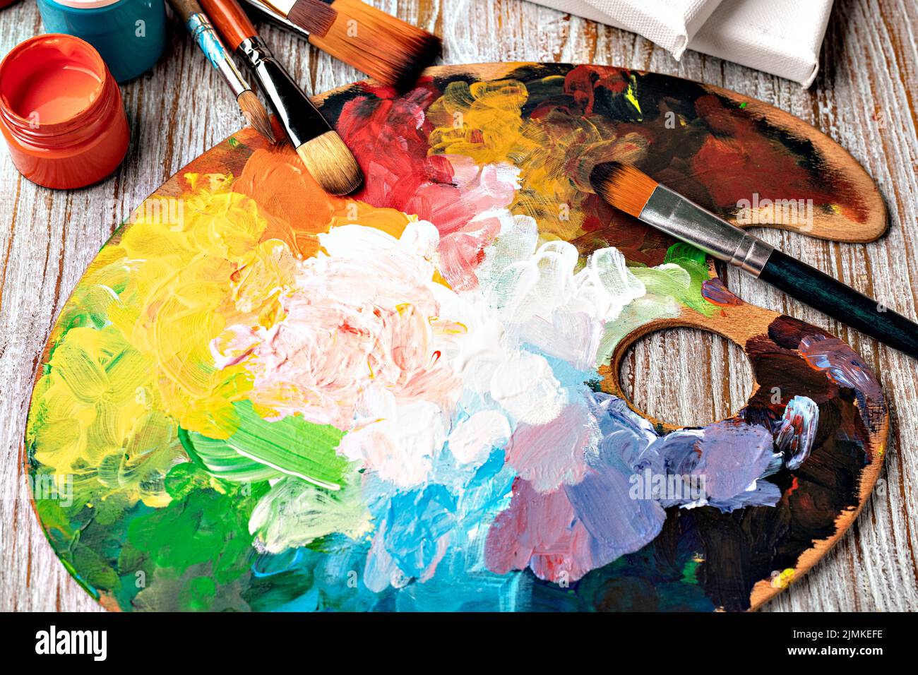 Art palette with colorful mixed paints Stock Photo - Alamy