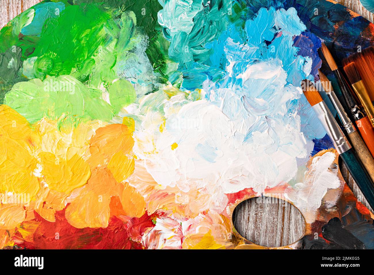 Art palette with colorful mixed paints Stock Photo - Alamy