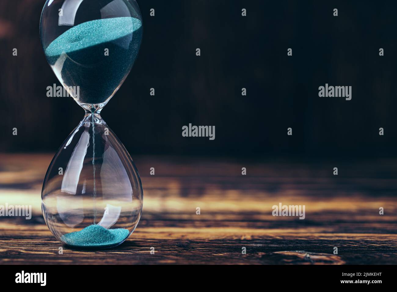 Hourglass with green sand Stock Photo - Alamy