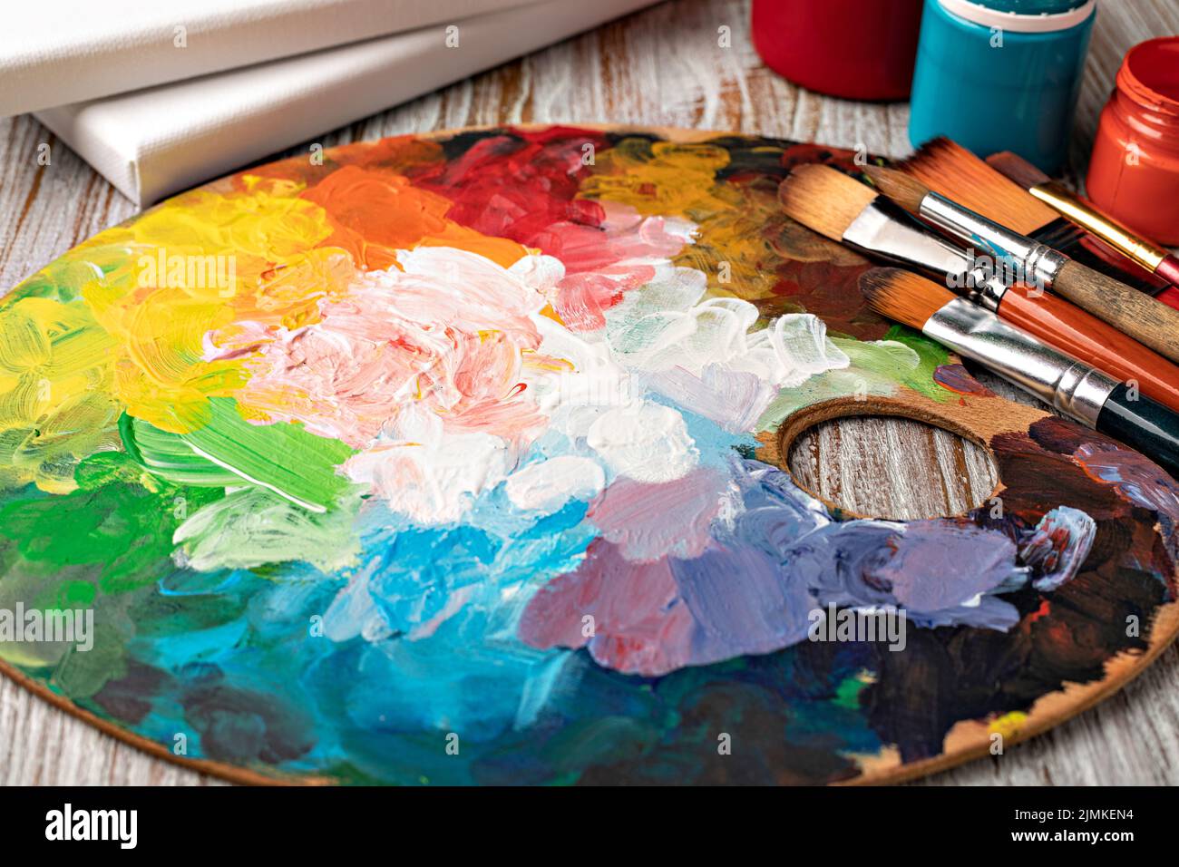 Art palette with colorful mixed paints Stock Photo - Alamy