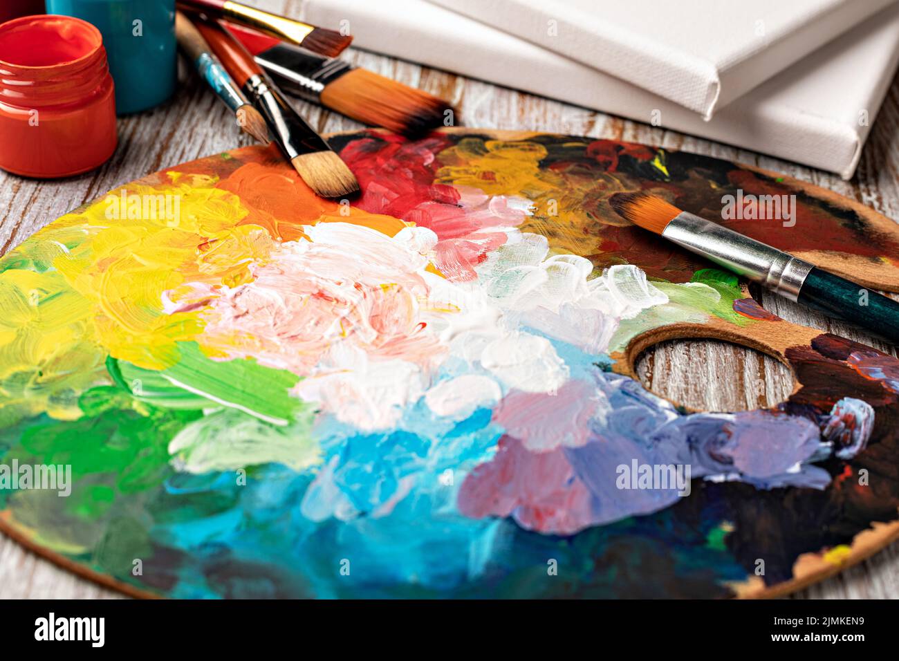 Art palette with colorful mixed paints Stock Photo - Alamy