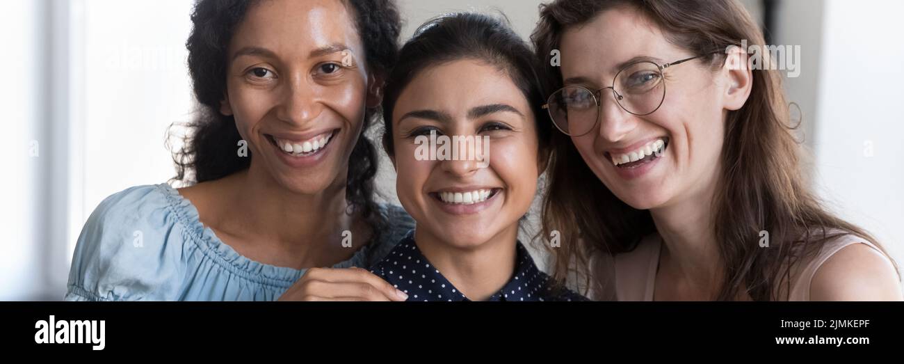 Horizontal photo three laughing multi ethnic women, cropped portrait ...
