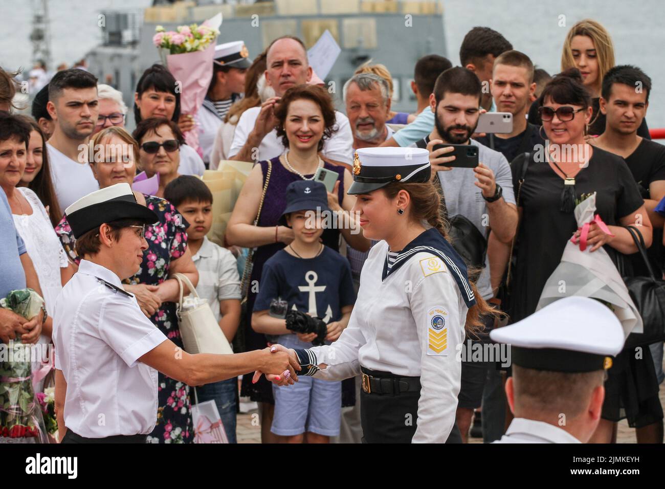 A graduate is seen shaking hands with their teacher. Graduation ...