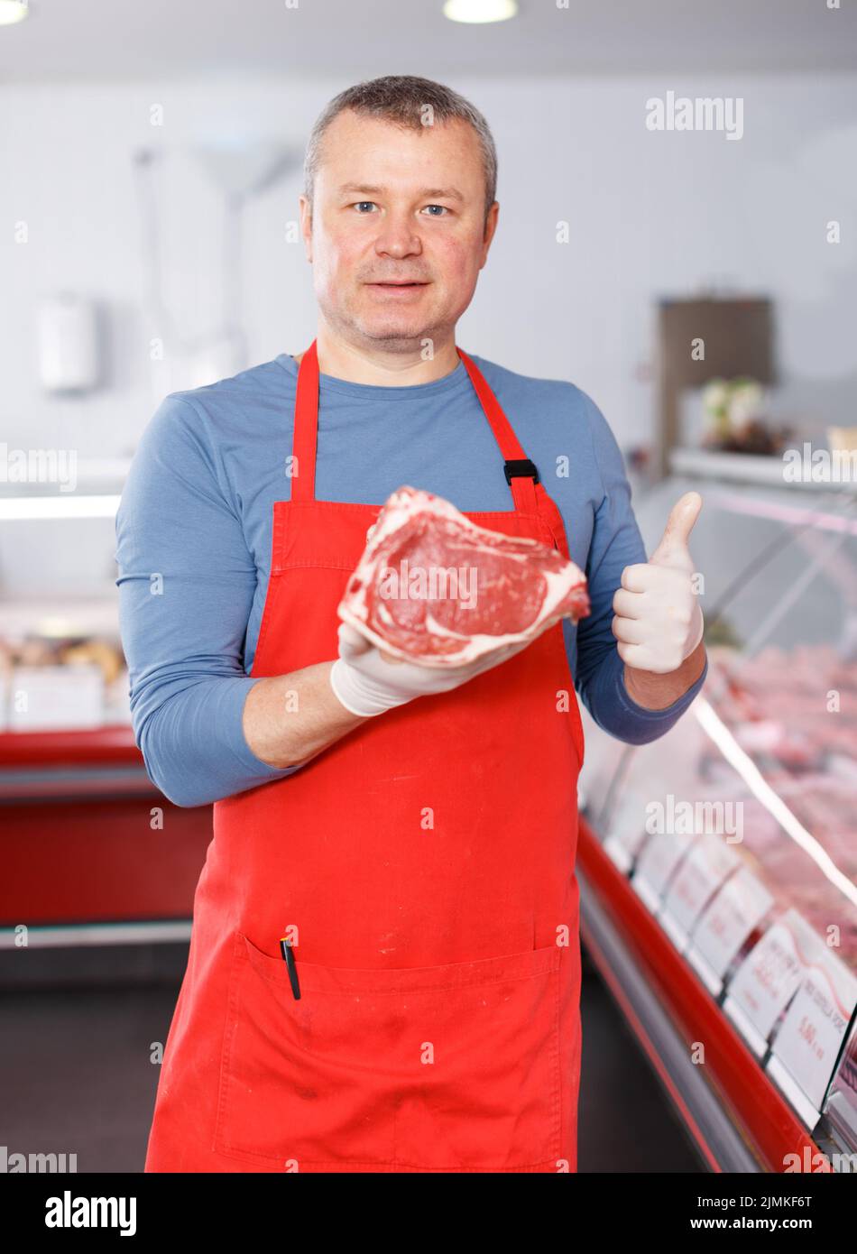 Happy butcher showing meat hi-res stock photography and images - Alamy