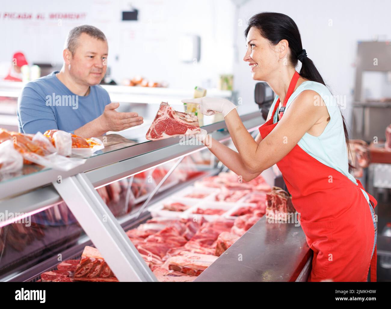 Butcher showing meat customer hi-res stock photography and images - Alamy