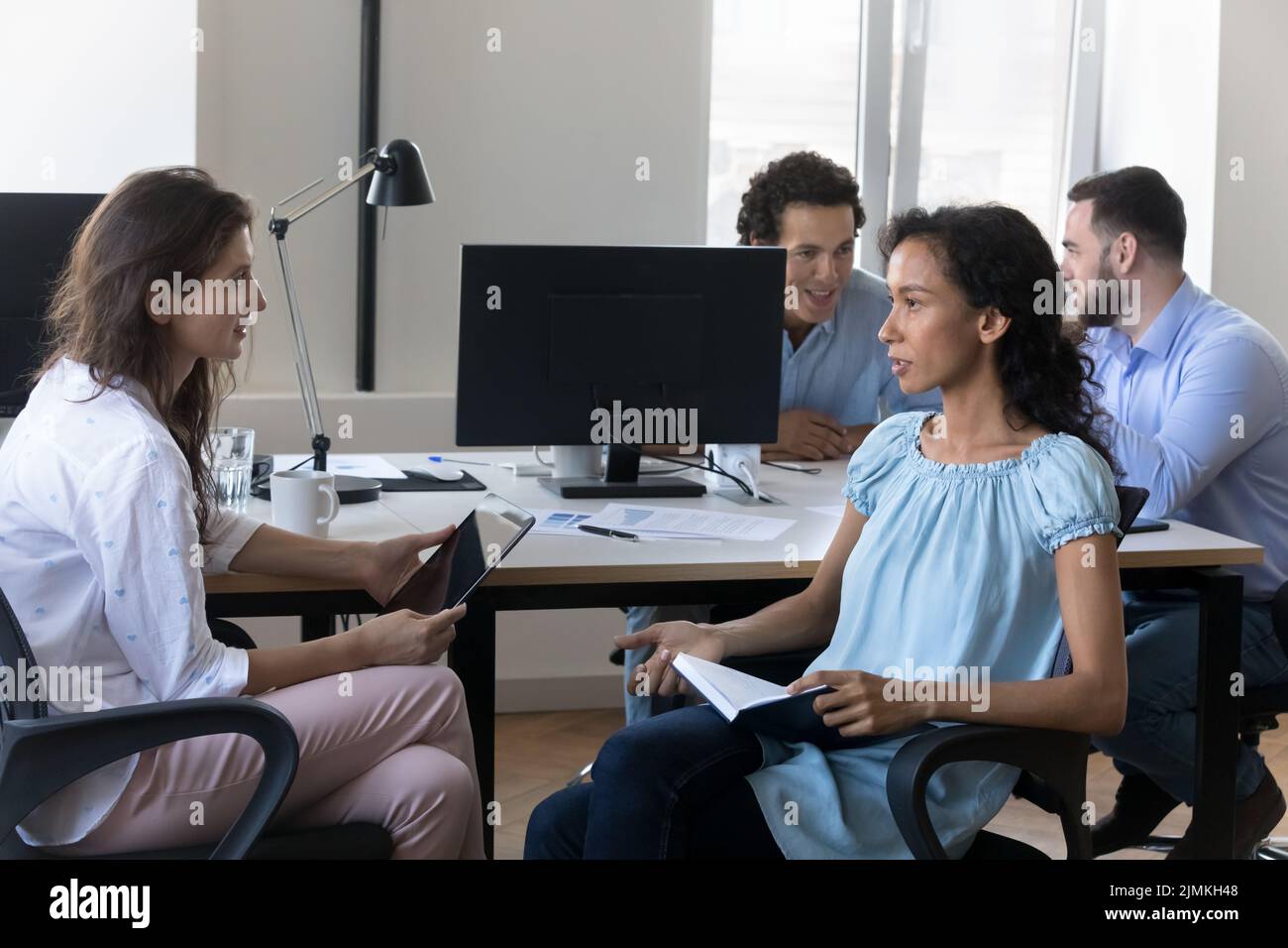 Diverse colleagues talking in modern co-working office Stock Photo - Alamy