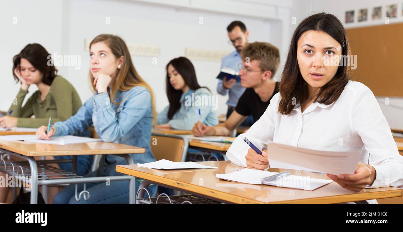 Girl writing test in classroom Stock Photo - Alamy