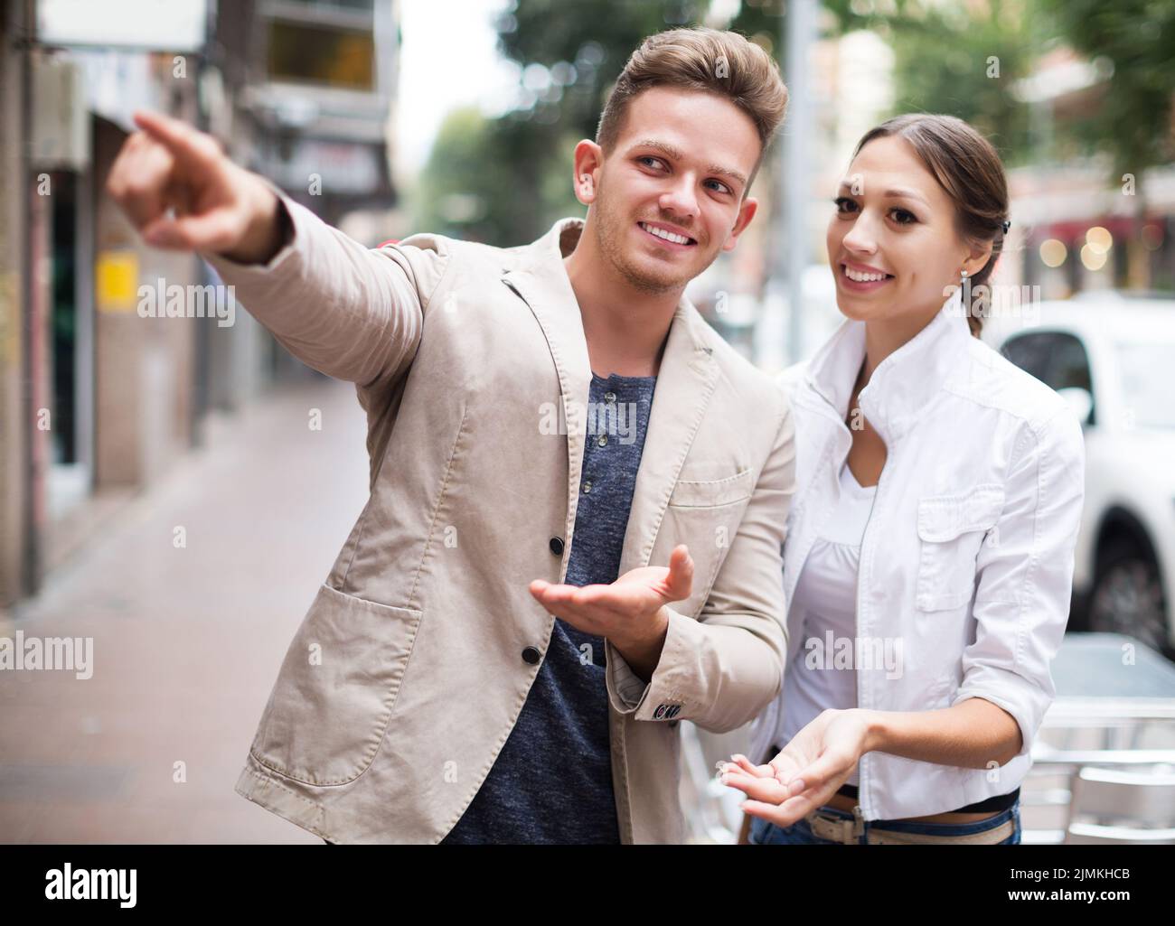 Traveller asking woman direction Stock Photo - Alamy
