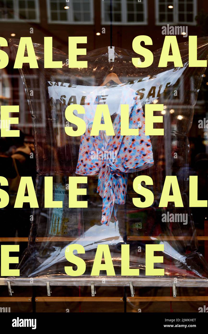 Sale, text in large bright letters on clothes shop window Stock Photo ...
