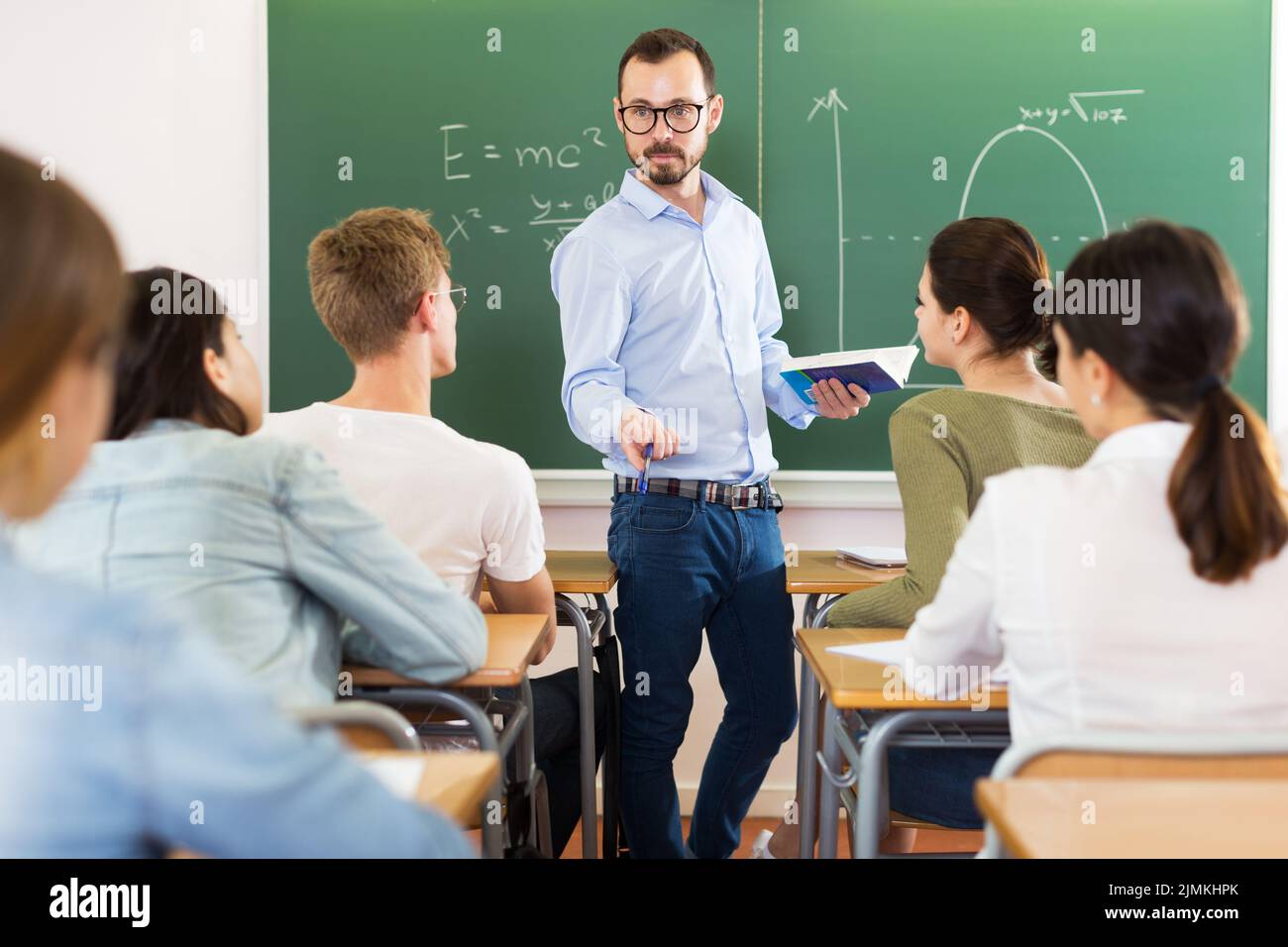 Male teacher giving lecture for students Stock Photo - Alamy