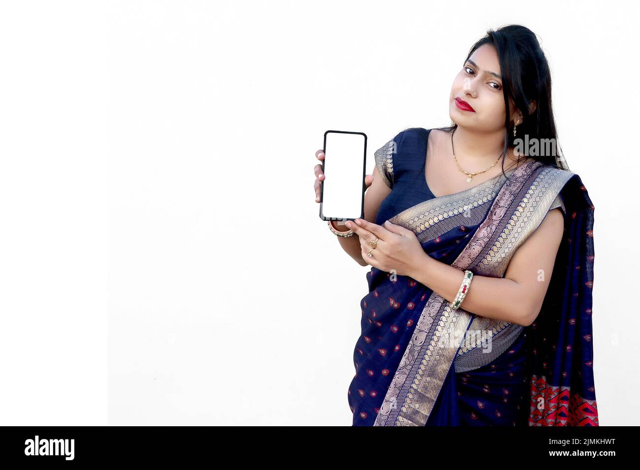 A Portrait of happy beautiful indian female wearing saree holding a ... A Portrait of happy beautiful indian female wearing saree holding a ...